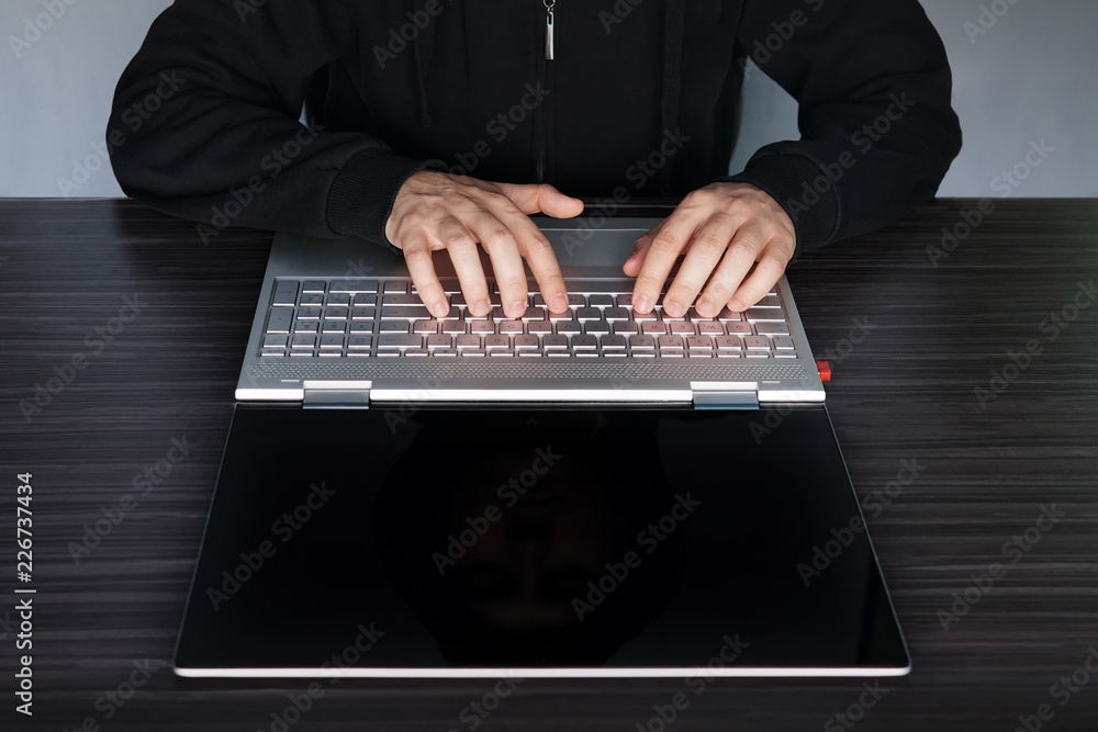 Hands typing on keyboard computer laptop with blank copy-space screen ...