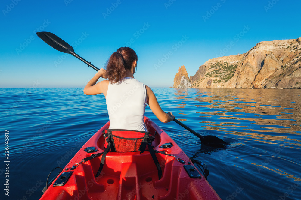 Kayaking. A Woman in a Kayak. Girl Paddling in the Calm Sea water near ...