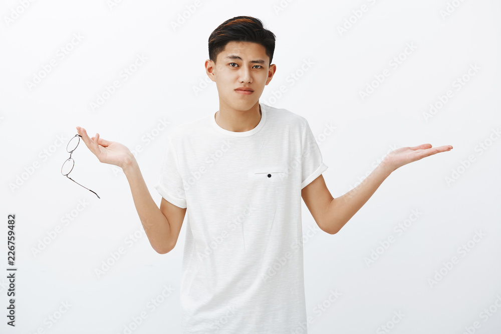 Questioned asian guy cannot understand what problem. Portrait of ...