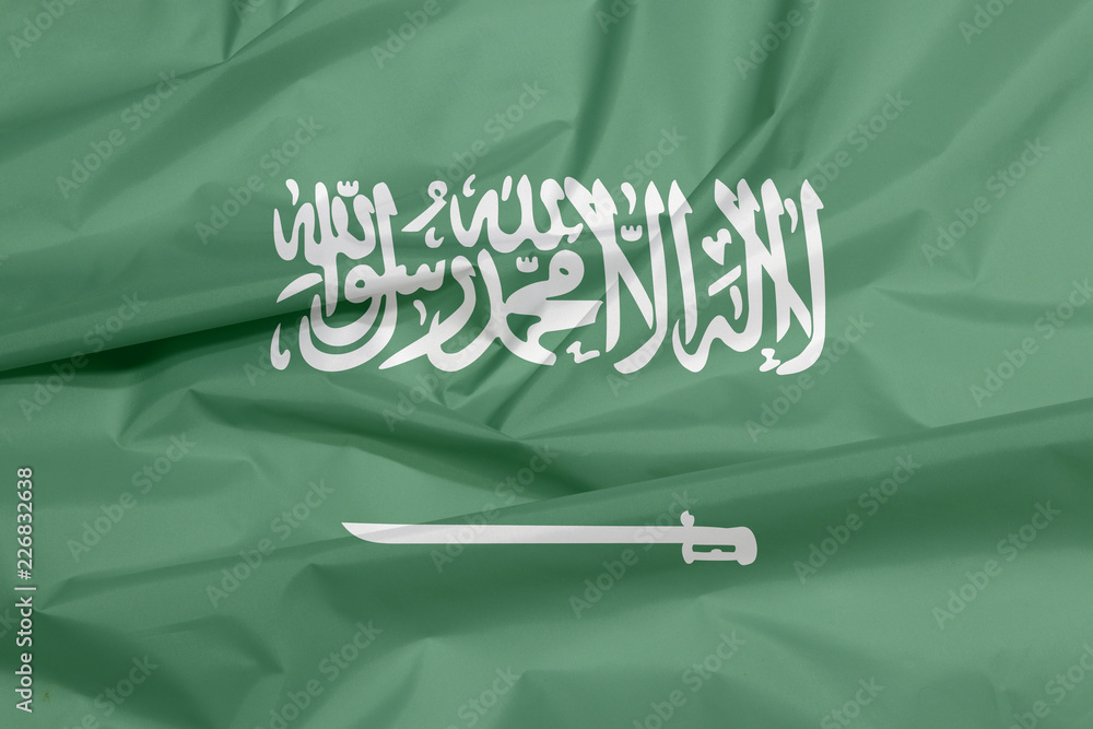 Fabric flag of Saudi Arabia. Crease of Saudi Arabian flag background, a ...