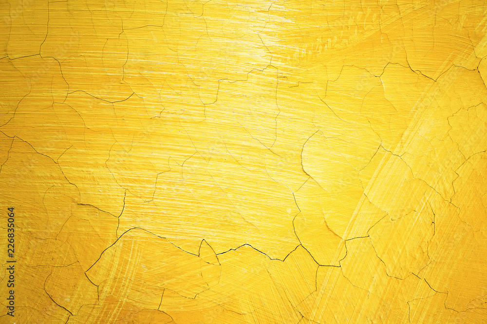 Cracked yellow paint on wall. Old exterior surface texture ...