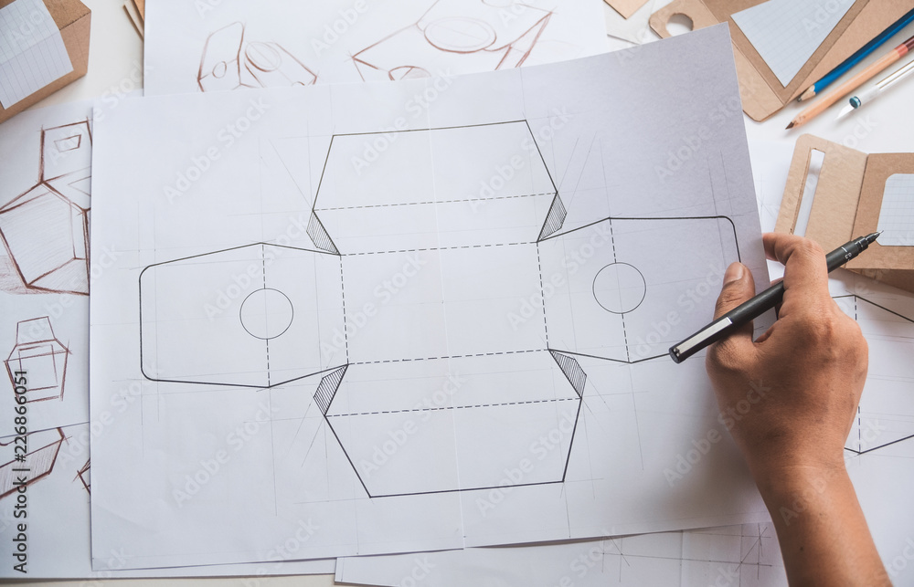 Designer sketching drawing design Brown craft cardboard paper product ...
