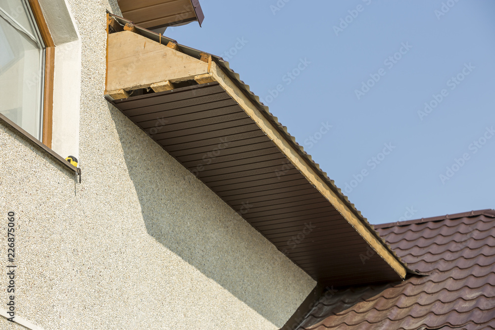 Bottom view detail of new modern house cottage corner with stucco walls ...
