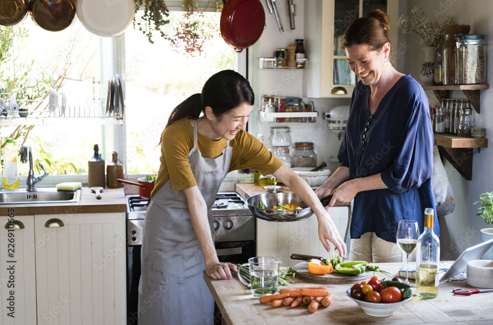 Friends cooking in a countryside kitchen Stock Photo | Adobe Stock