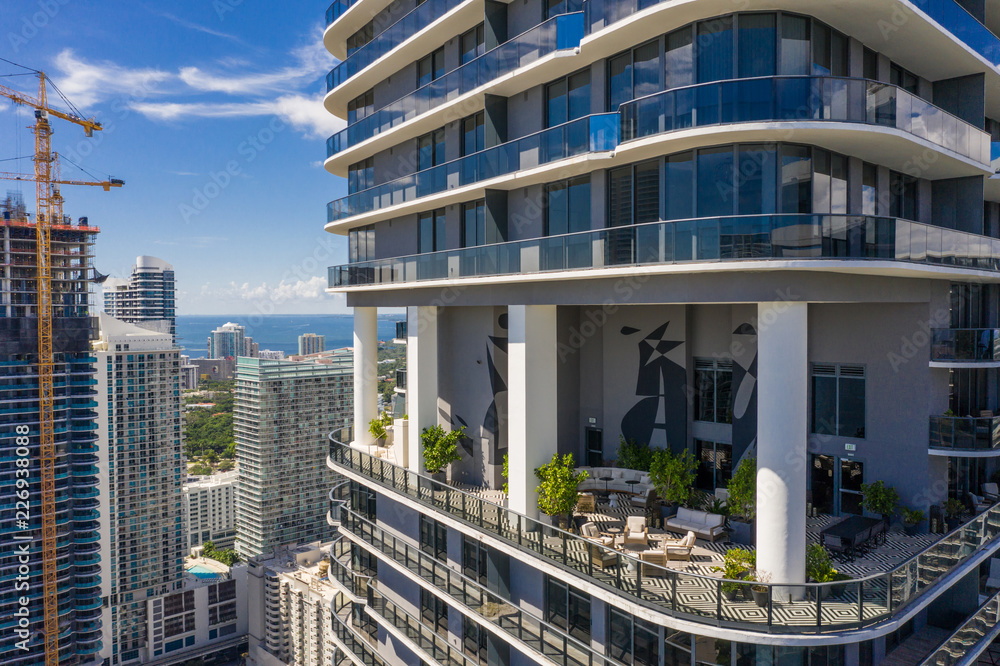Aerial Miami Brickell highrise tower with recreational amenities area ...