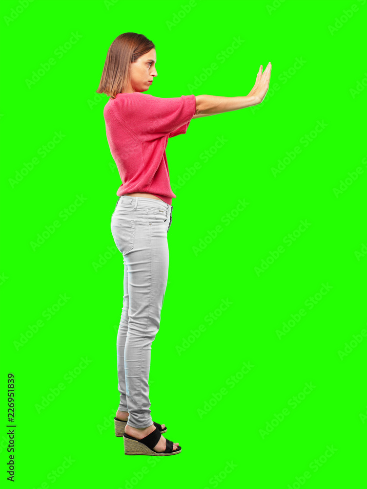 young woman full body. signaling stop with both palms of hands facing ...
