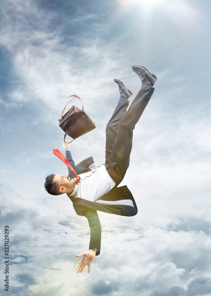 The frightened businessman in suit falling down and screaming against ...