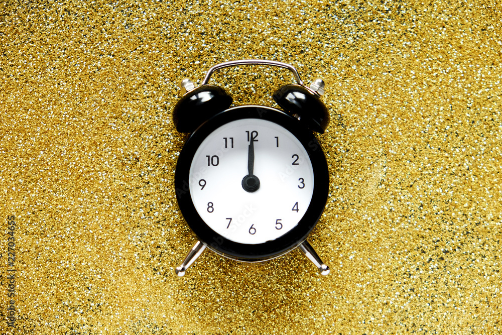 Holiday coundown concept. Old alarm clock that shows 12 AM time laying ...