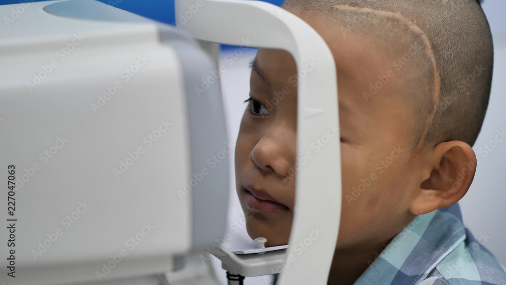 eyesight check. Asian boys who have vision disabilities. Left eye is ...