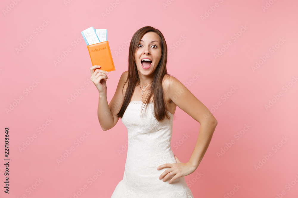 Amazed excited bride woman in white wedding dress holding passport and ...