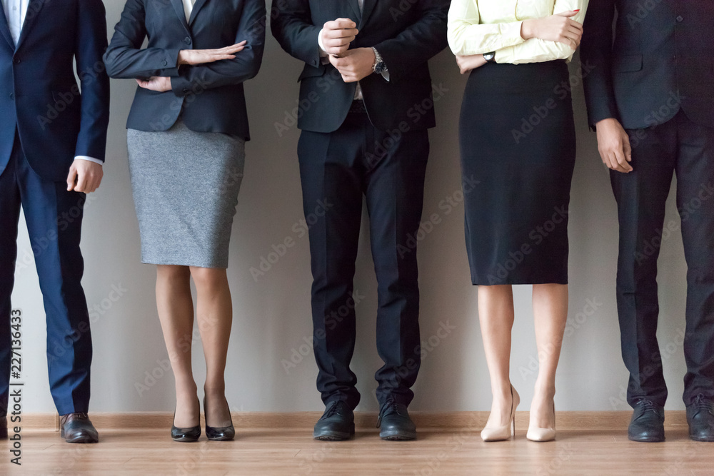 Legs of diverse work team pose for corporate photoshoot or make picture ...