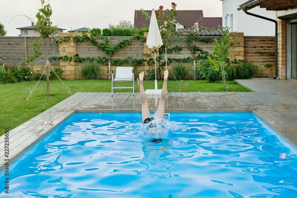 Girl jumps into the pool, photo shows the legs up sticking out of the ...