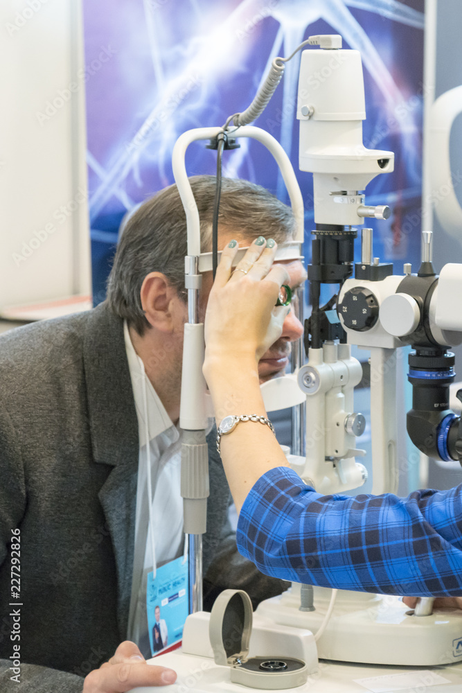 Patient eye doctor checkup patient eyes with apparatus. health care ...