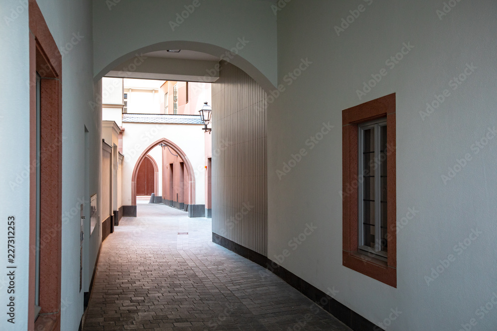 Poster Undercover cobbled passage leading to a courtyard – Wall Art ...