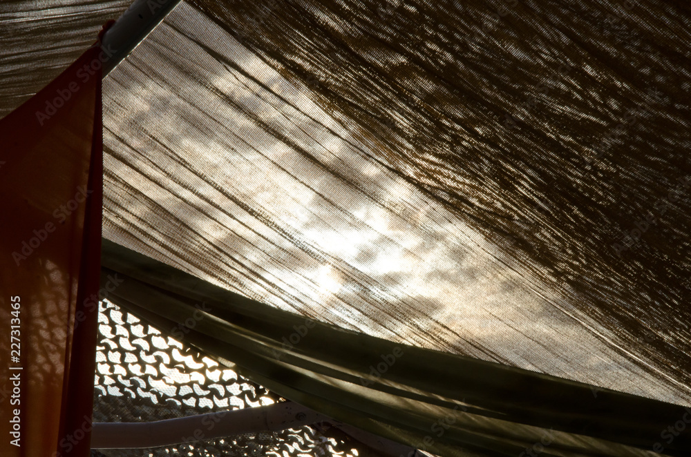texture of brown tent, sun behind fabric texture, backlit, sunny day at ...