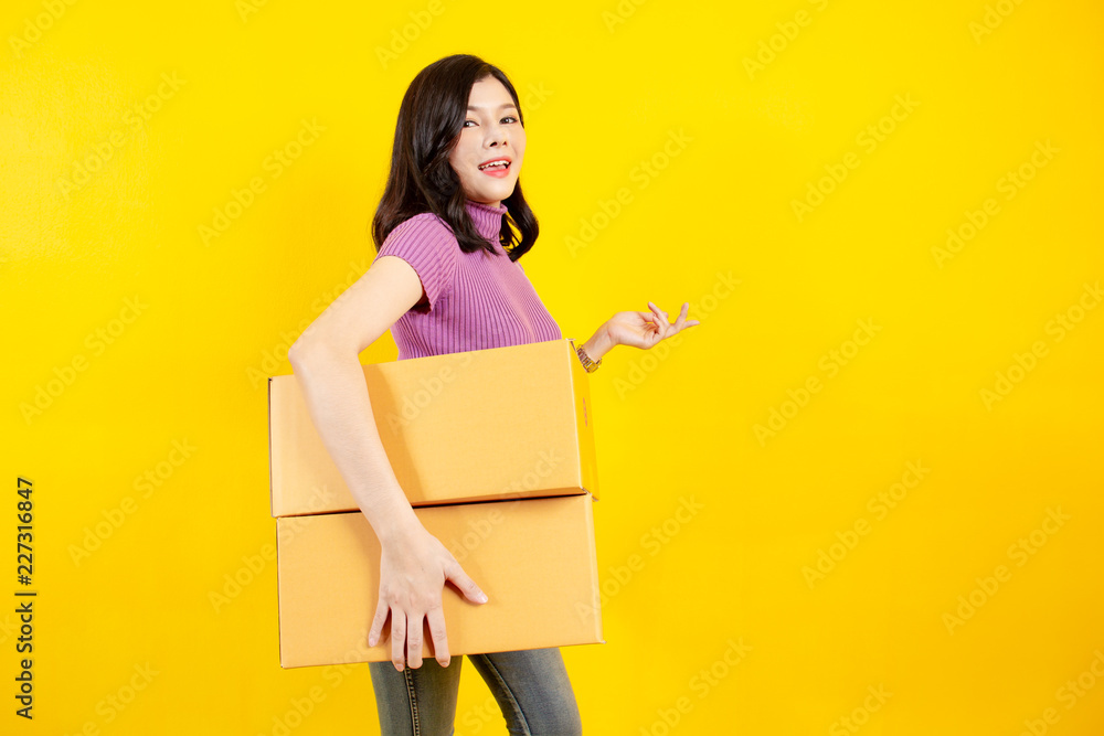 Portrait of the beautiful Asian girl carrying a parcel boxes close up ...