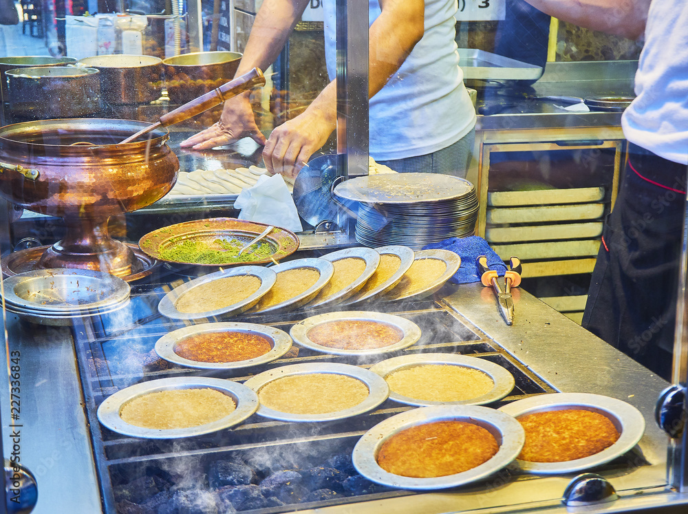 Cooking Kunefe, also known as Kenafeh, a traditional Arab dessert made ...