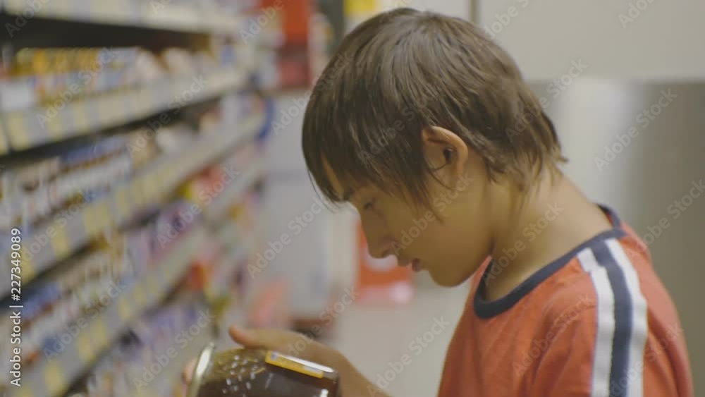 Teenager in supermarket. Close-up of caucasian teen boy in red t-shirt ...