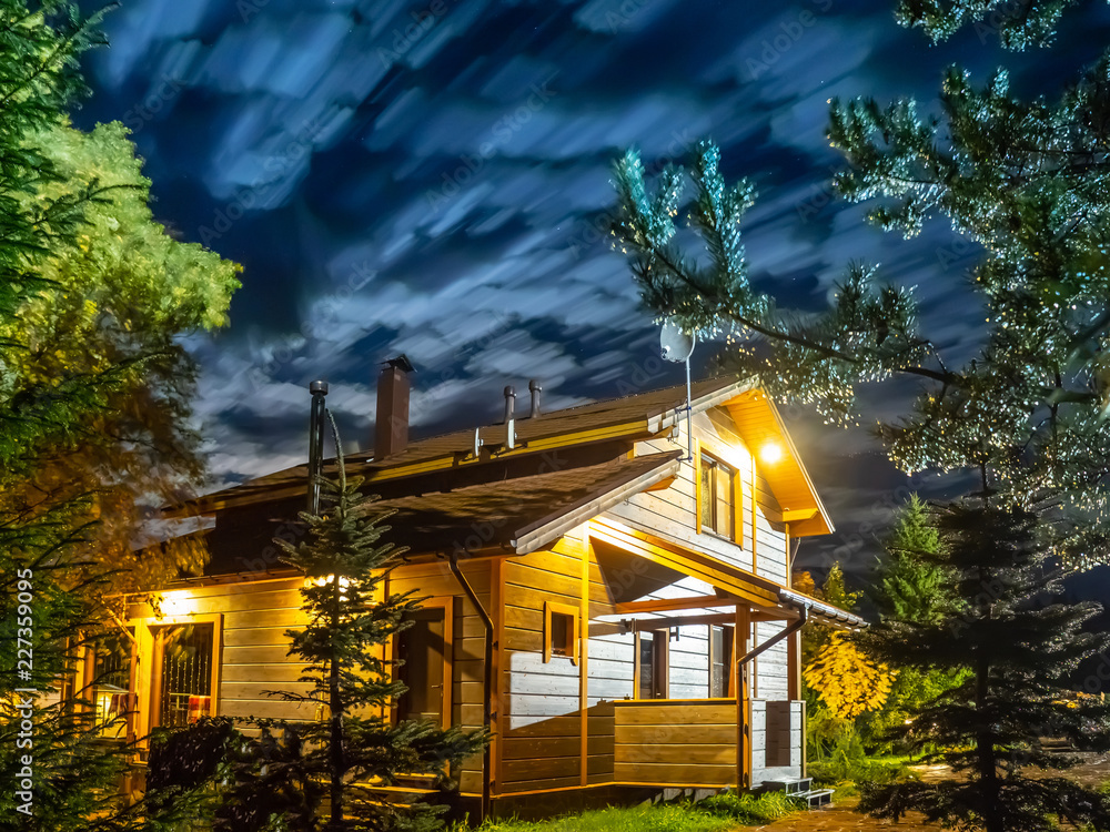 Cottage on the background of the night sky. House with street lighting ...
