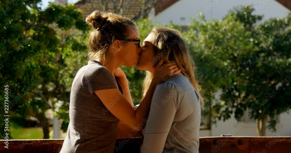 Lesbian couple kissing each other in balcony 4k Stock ビデオ | Adobe Stock