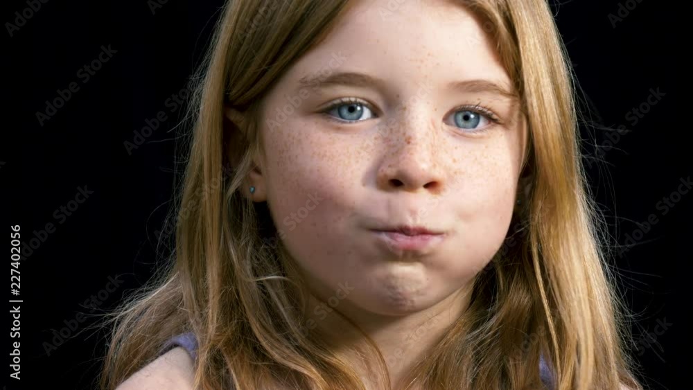 Young girl being silly and puffing our her cheeks Stock Video | Adobe Stock
