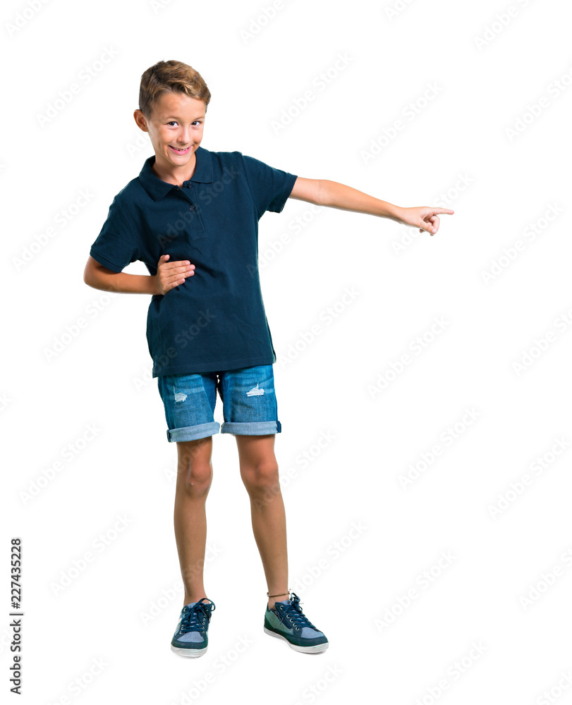 Full body of Little boy pointing finger to the side and presenting a ...