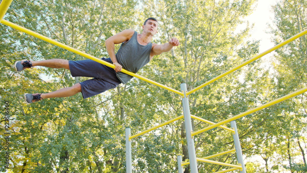 Pull-up strength training exercise. Slim athlete a very fit guy fitness ...
