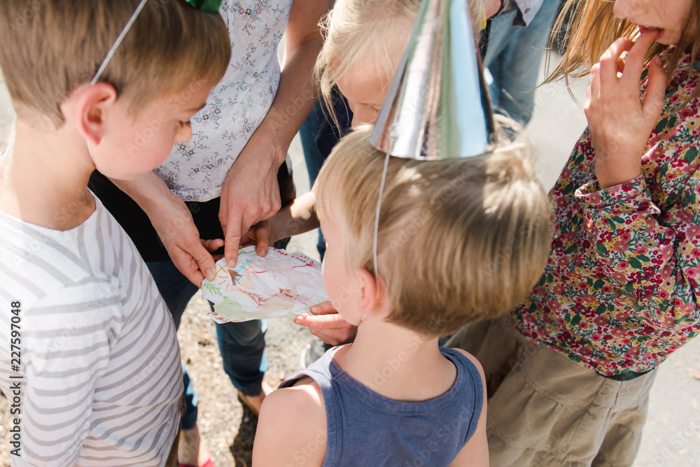 kids reading a map on treasure hunt Stock Photo | Adobe Stock