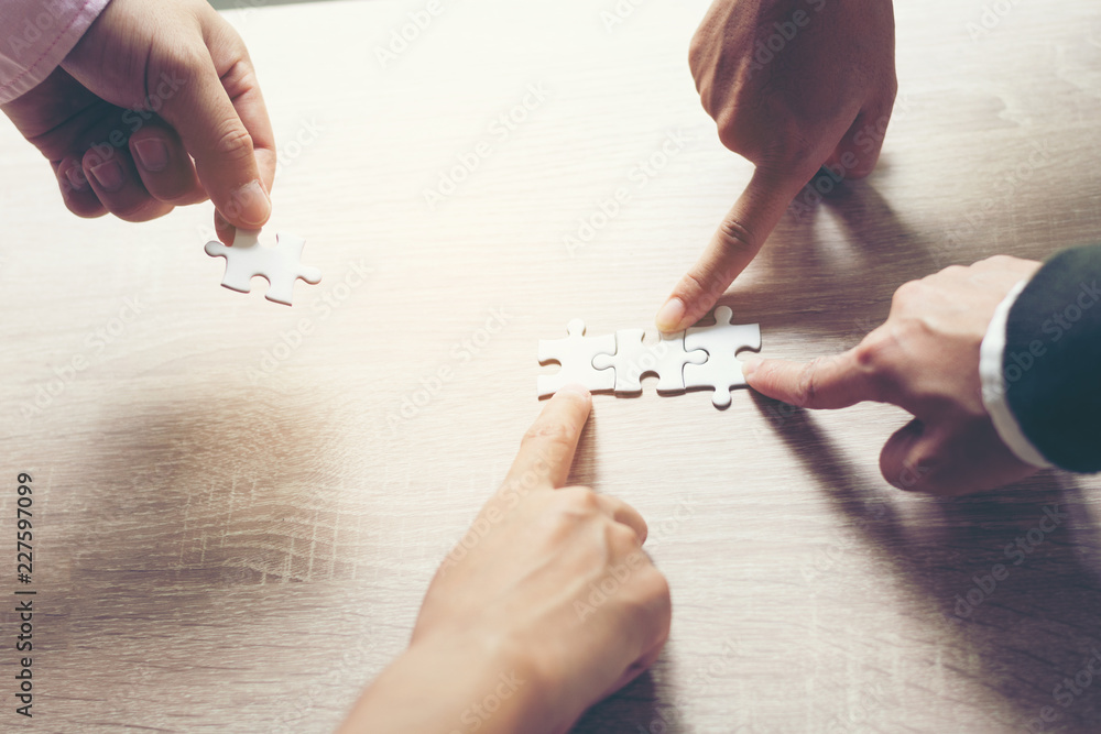 team hand power full placing the jigsaw puzzle piece for conect ...