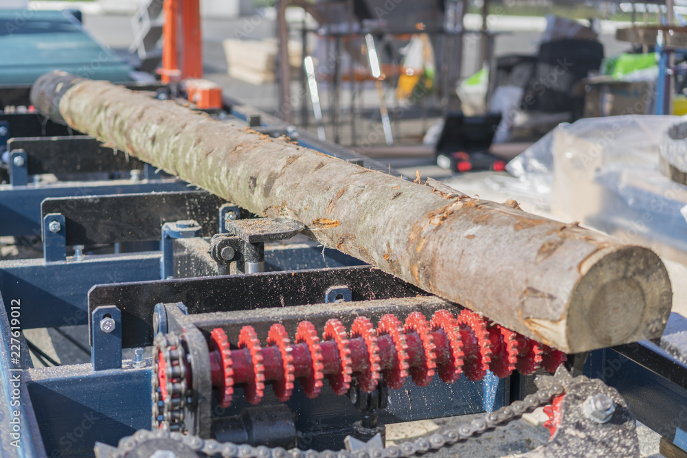 Partially milled log on a portable lumber milling machine. Stock Photo ...