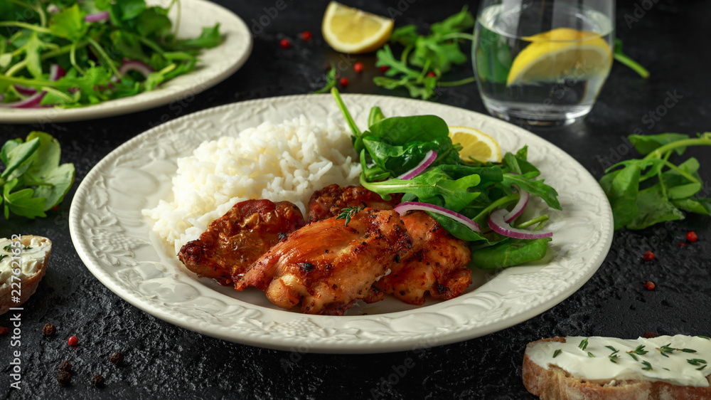 Roasted boneless skinless chicken thighs with rice and green vegetables ...