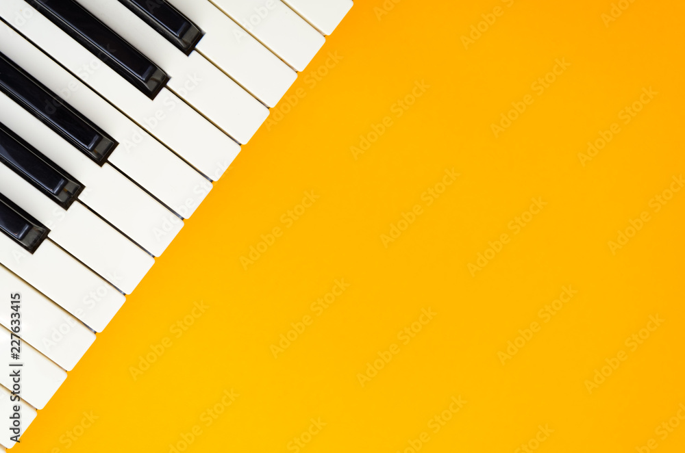 Abstract orange background with the piano keys in the up-left corner ...