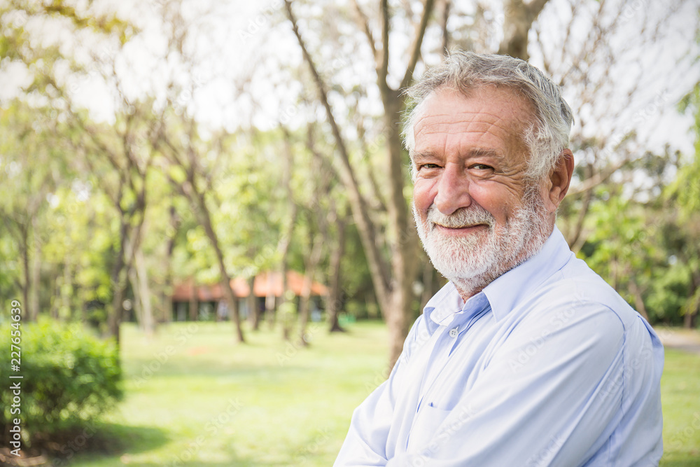 Portrait of healthy happy senior caucasian old man in the park outdoors ...