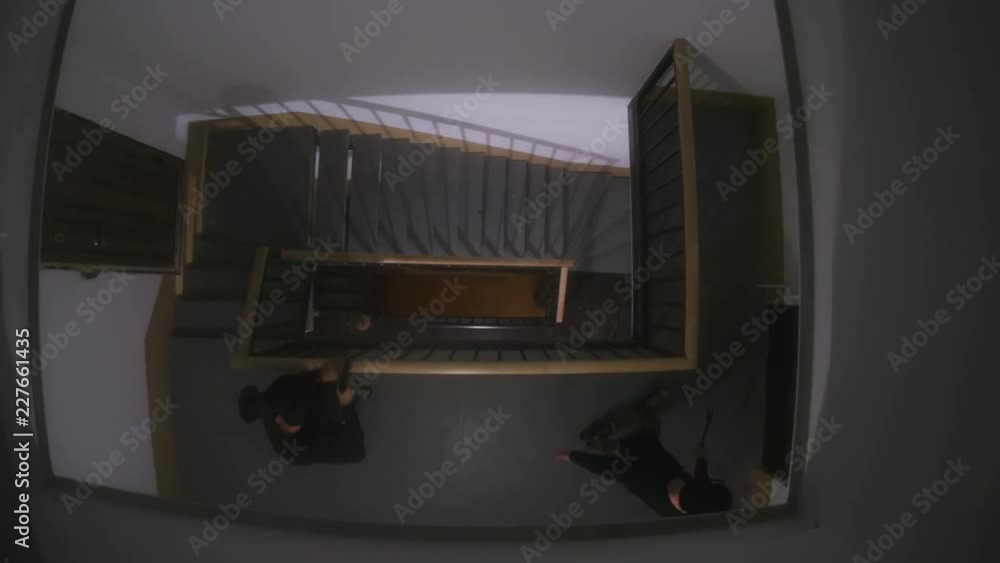 Two bizzare men in black clothes sneaking up on door. Masked men with ...