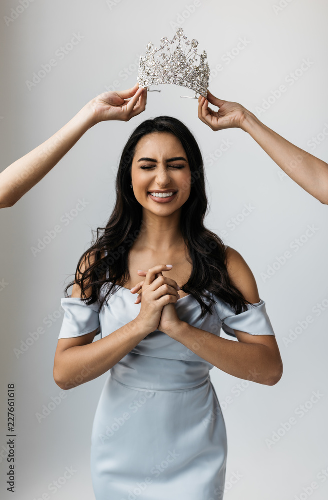 Attractive model receiving an award for winning beauty pageant ...