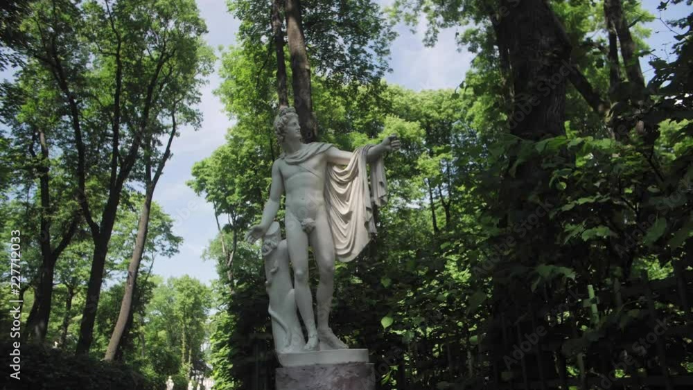 Statue of Apollo Belvedere in a Summer Garden park, sunny trees in the ...