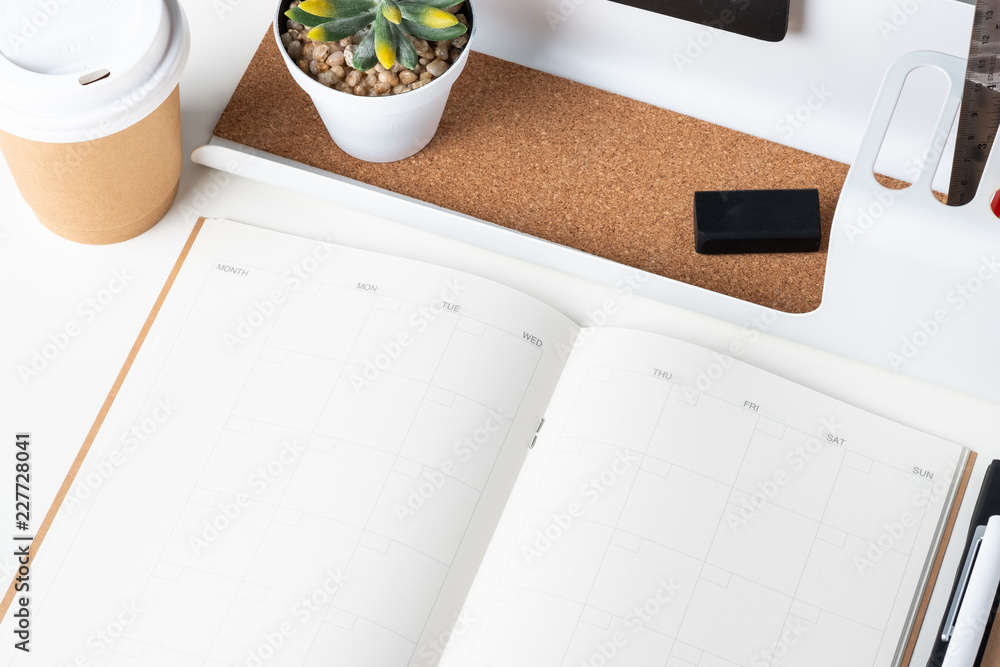 top view of open calendar planner with modern office stationery and ...
