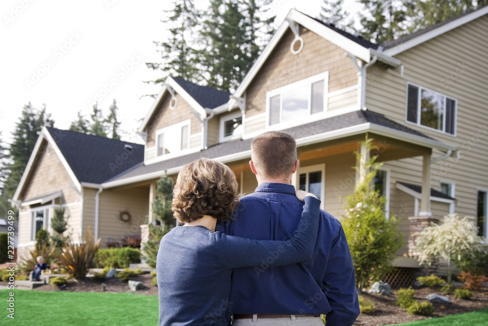 happy couple in front of house in front of new house Stock Photo ...