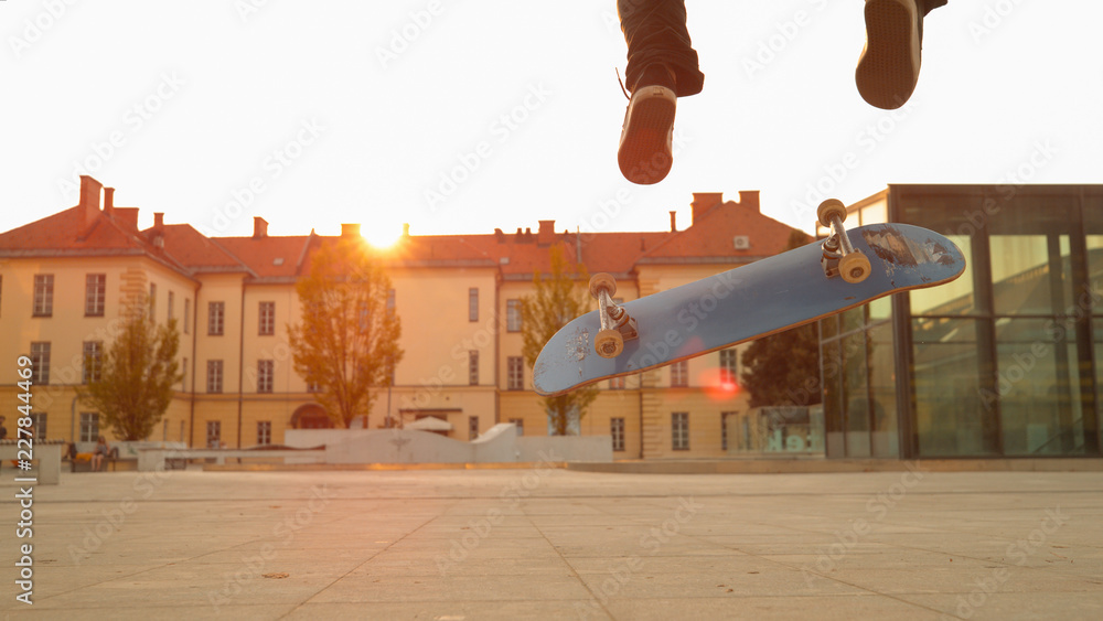 LENS FLARE: Unrecognizable athletic male does a flip trick on his ...
