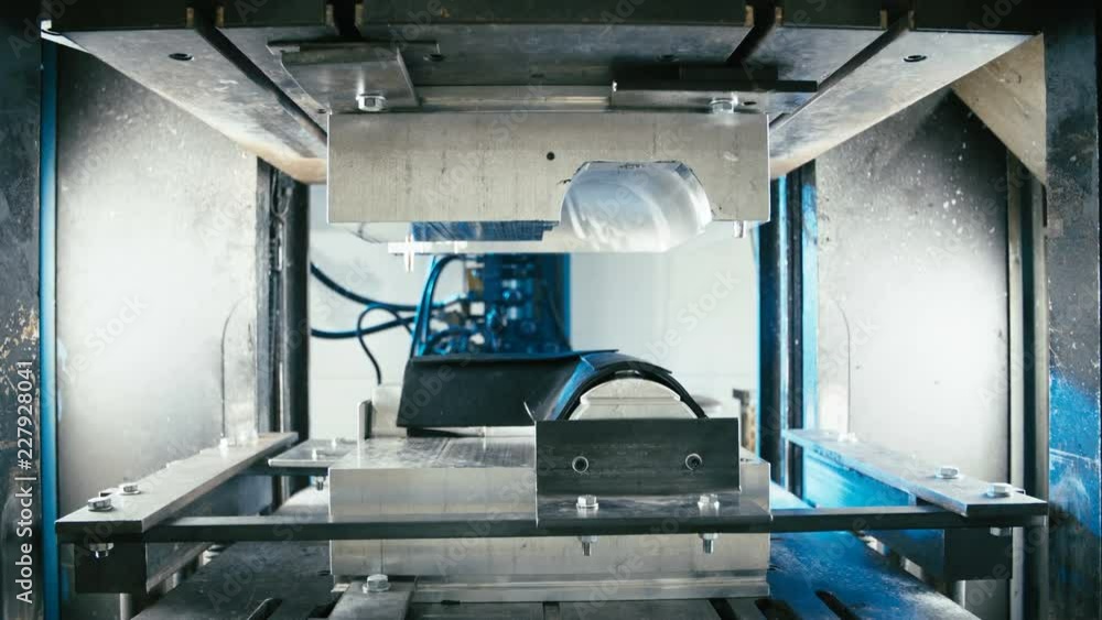 Industrial press machine 4K. Wide view of a press machine in focus ...