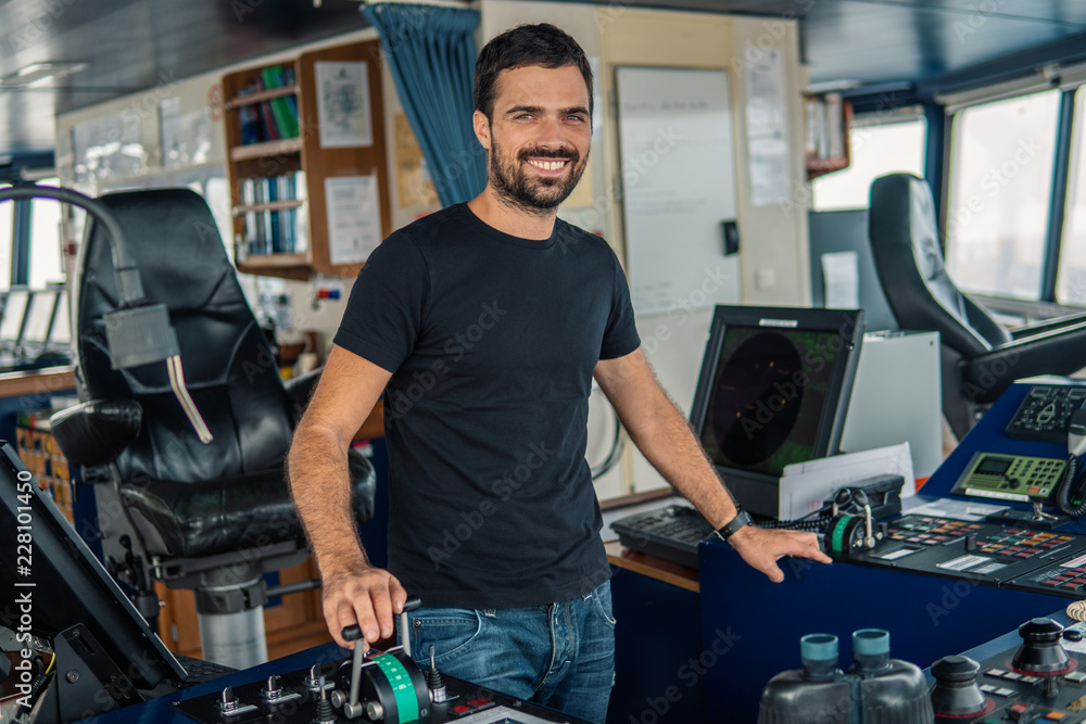 Marine navigational officer is maneuvering ship or vessel during ...