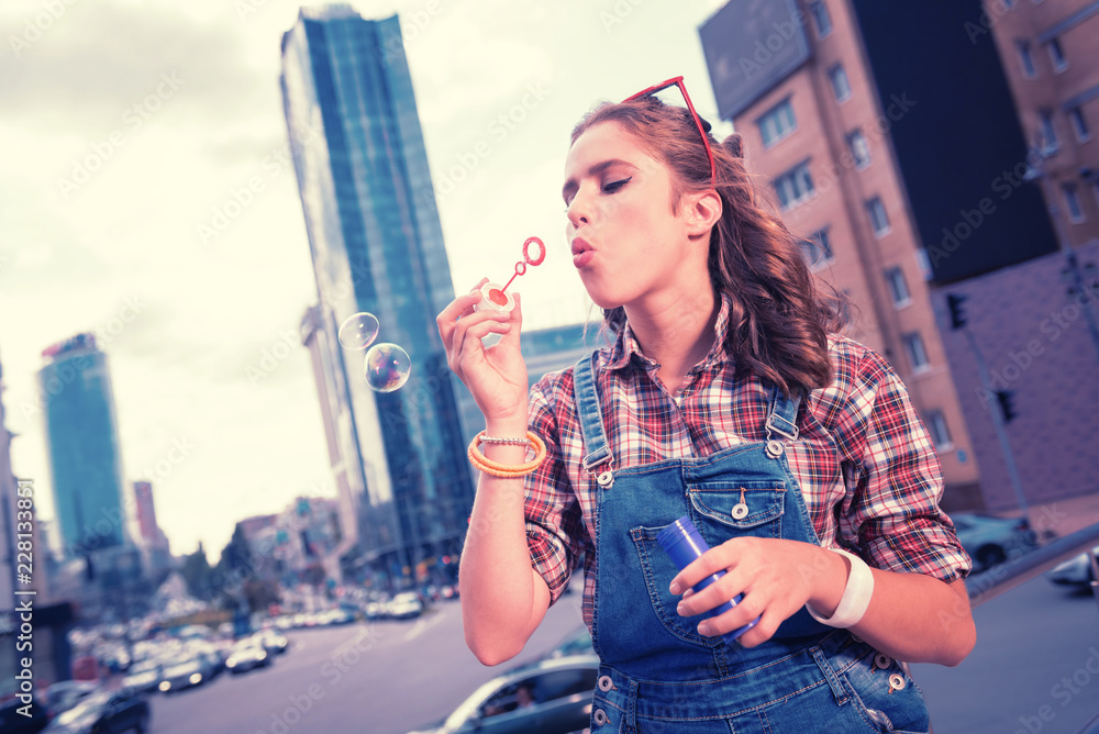 Girl with bubbles. Stylish school girl wearing white smart watch on her ...