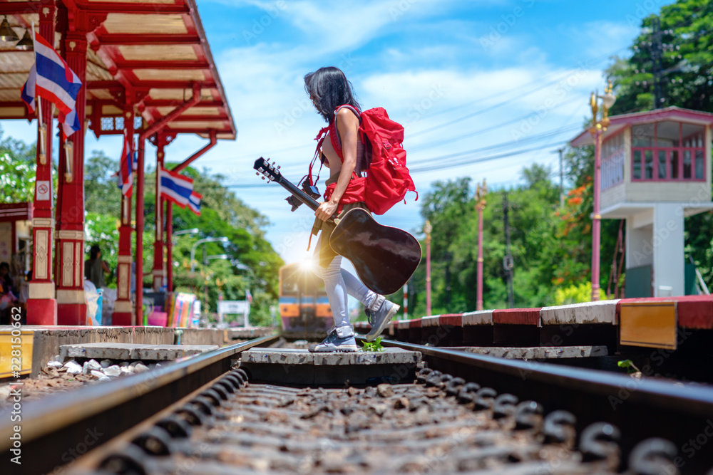 Foto de young woman running across railway at risk of the incoming ...