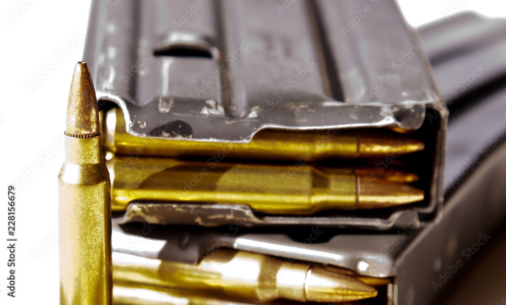 Two metal rifle magazines, one stacked upon the other, loaded with .223 ...