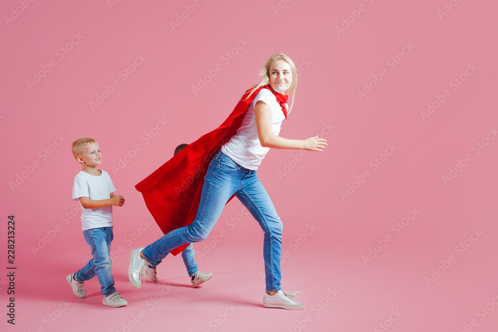 Mom is a superhero. Fun family, a young blond woman in a red Cape and ...