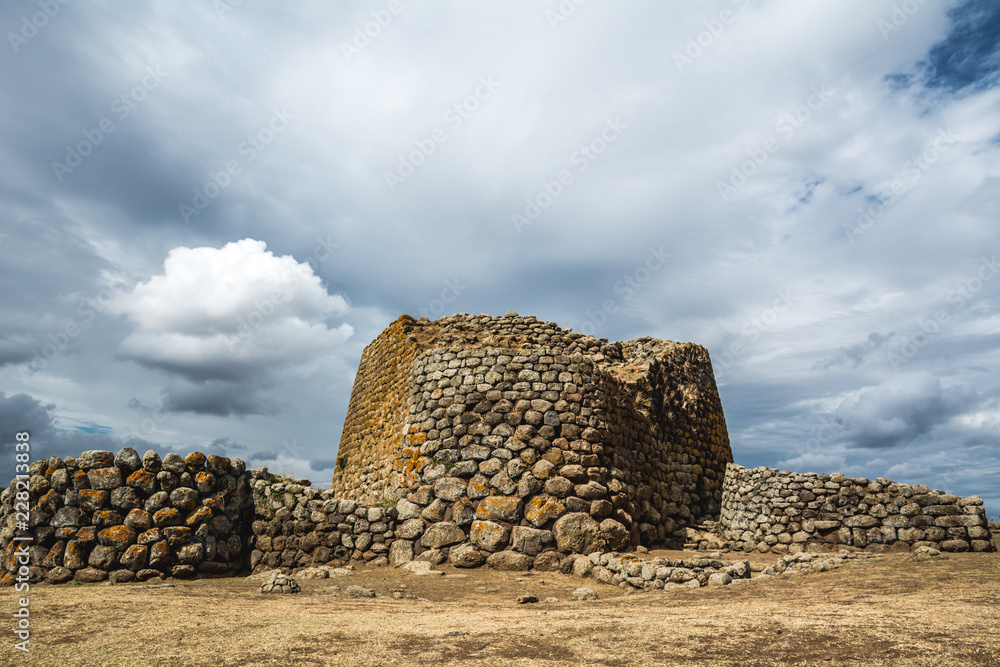 Typical nuraghe site in Sardinia, Italy with picturesque clouds before ...