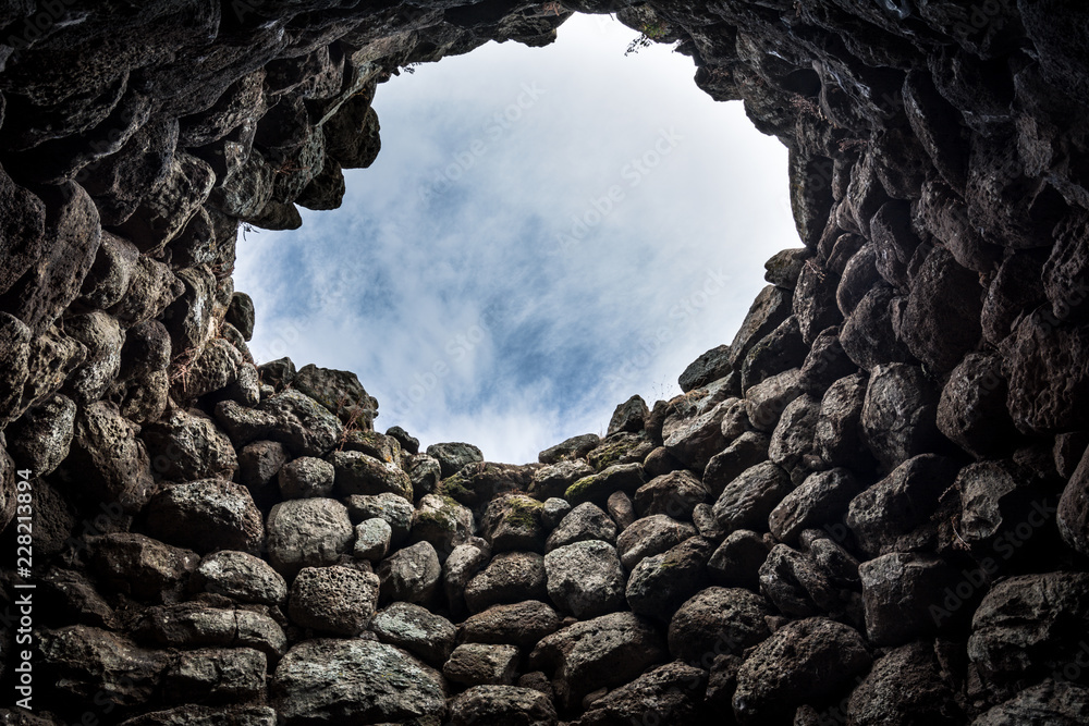 Typical nuraghe interior with overhead opening to allow light in it in ...