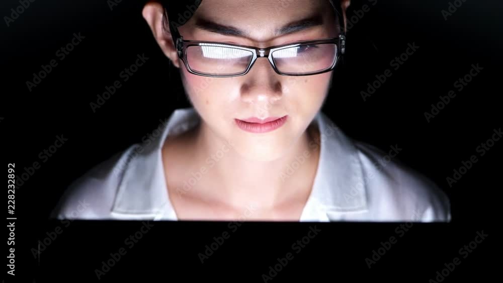 Woman working late at her home office. Close up of beautiful asian ...