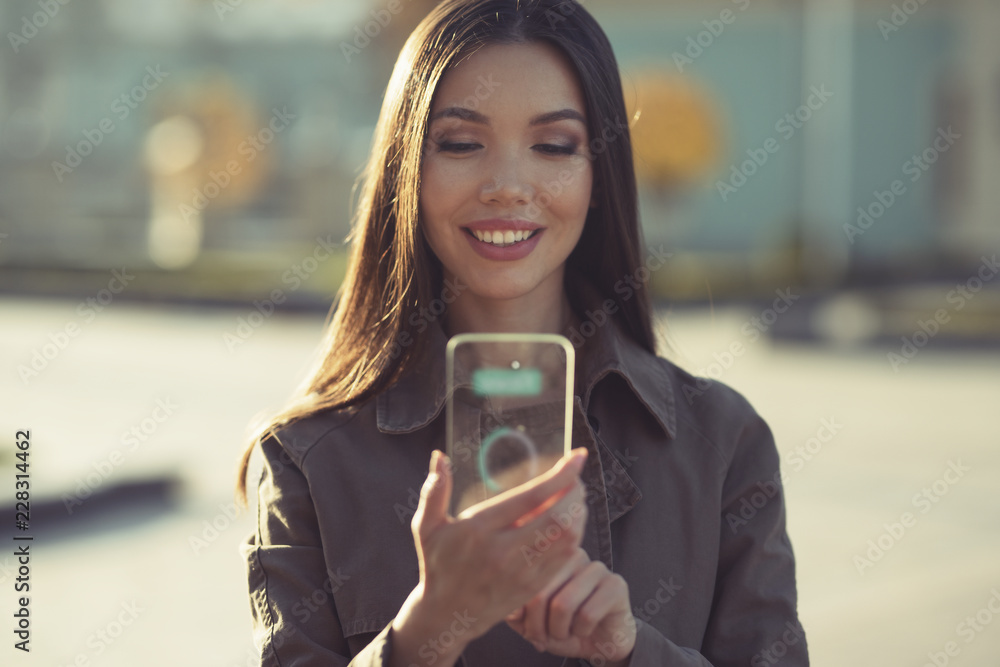 Transparent phones and gadget of the future concept, a beautiful young ...
