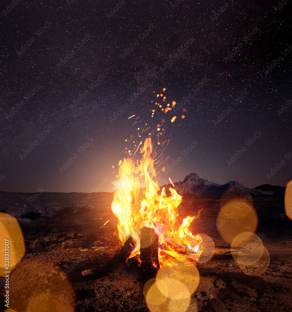 Watching the stars around a glowing warm campfire at night. Photo ...
